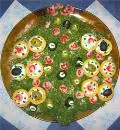 Salad sprinkle with greens, decorated with tartlets, shrimps, olives and olives