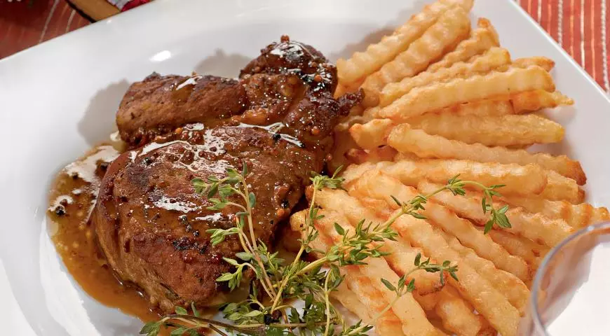 Pork chop in citrus sauce with french fries