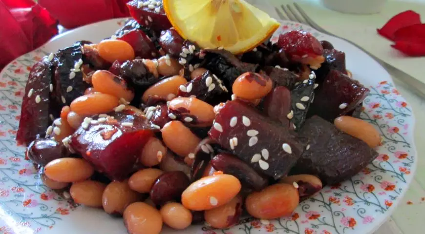 Preparing beet salad with beans and prunes