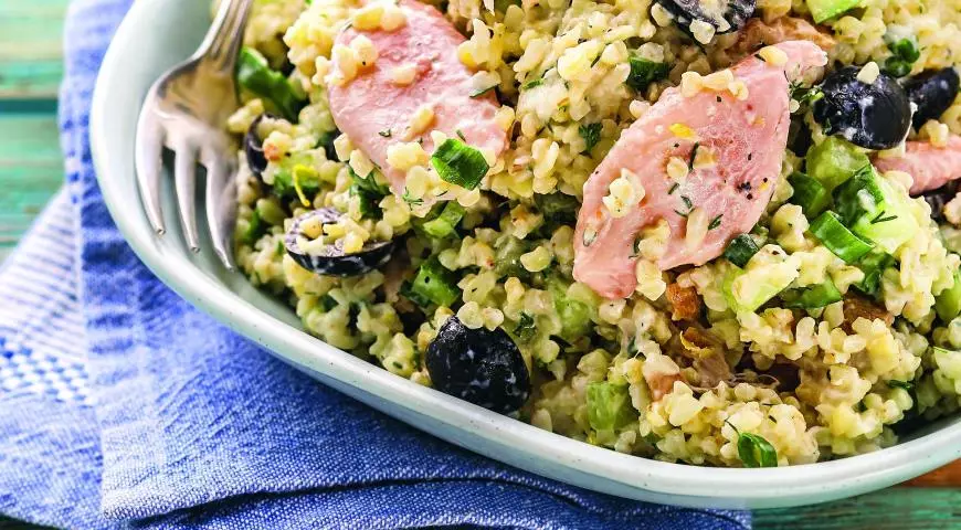 Pequeñas cebollas verdes. Los pepinos de divisas cortan en cubos pequeños, esculpan las aceitunas en las mitades. Mezcle el bulgur, las cebollas verdes, los pepinos y las aceitunas con reabastecimiento de combustible.