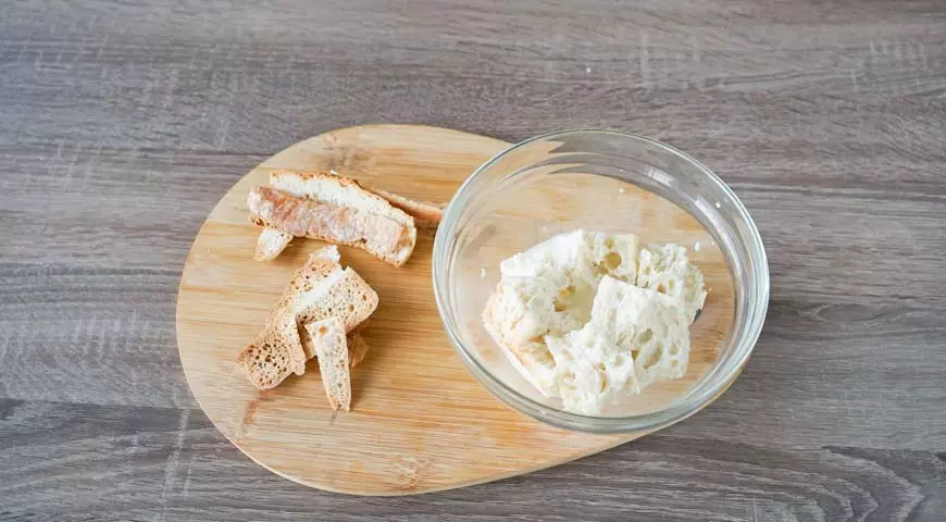 Mandonguilles de salsa de tomàquet, pa blanc es plega en un bol petit i omplir de llet freda