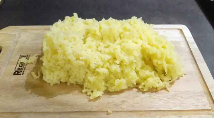 Boil potatoes and grate on fine grater