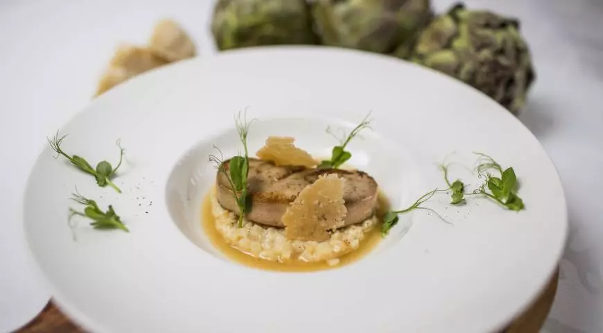 Cooking risotto from celery with duck fua gras and broth