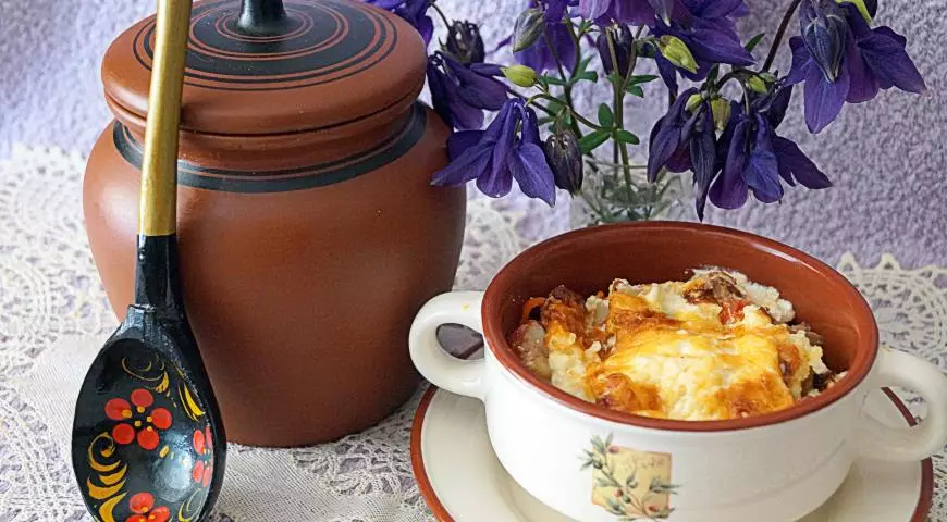 Cocinar trucha con papas y verduras en una olla.