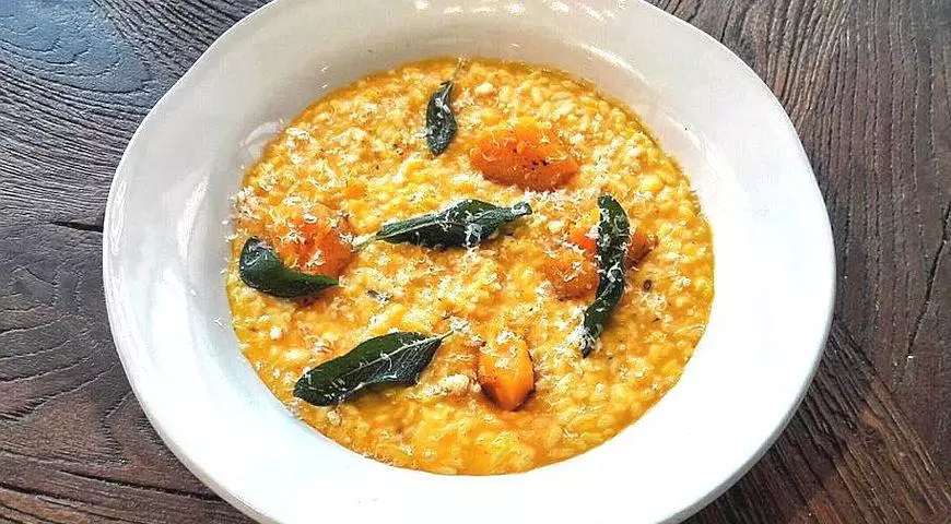 Risotto with pumpkin and squid in a plate