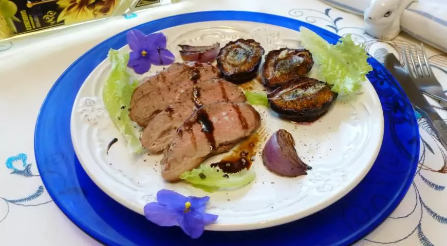 Cooking duck breast Medium Rare with dried plums and caramel bow