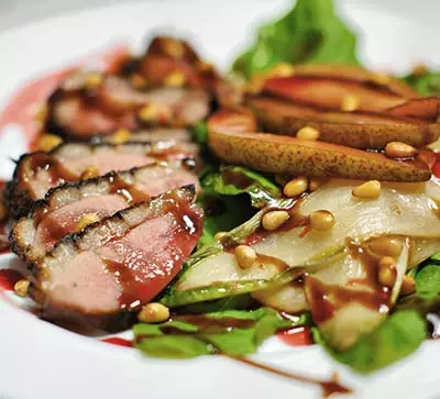 Duck breast with chicarium, sorrel and wine and pomegranate refueling
