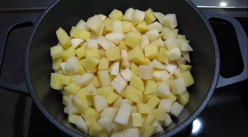 Cut potatoes and add to vegetables in Kazan