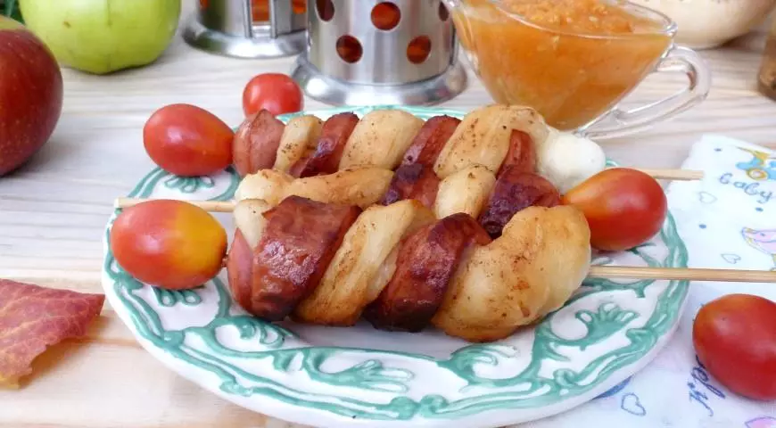 Delicious sausage with a dough on a skewer