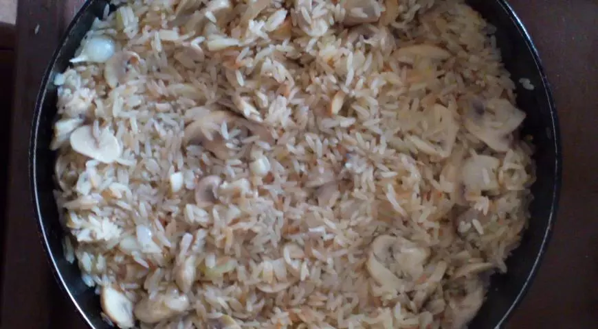 Kaynar su, krema ekleyin ve pirinç tamamen yumuşak olana kadar pişirin