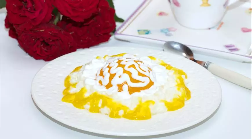 Cream rice porridge with orange sauce and peaches