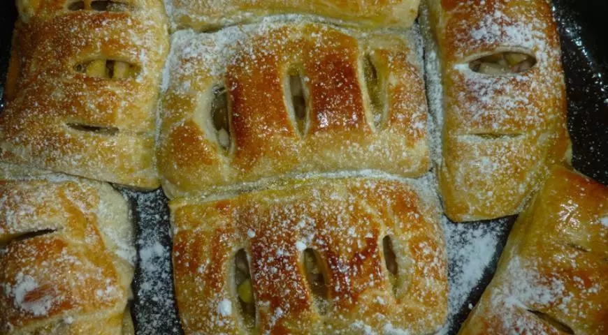 Bake puffs with apples in the oven, decorating sugar powder