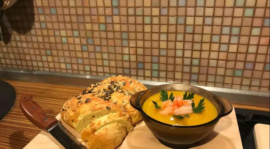 Pumpkin soup with tiger shrimps is ready for feed