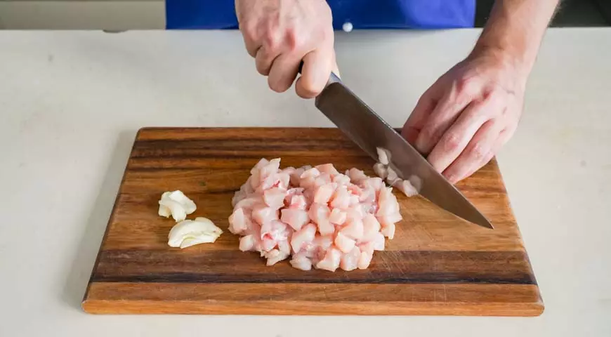 Salad pomegranate bracelet with chicken, chicken fillet Cut into small cubes, crosse the garlic with a knife