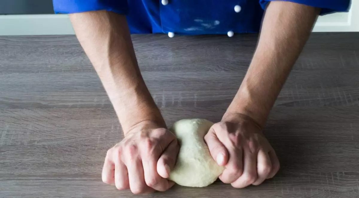 Strudel with apples, dress the dough with hands